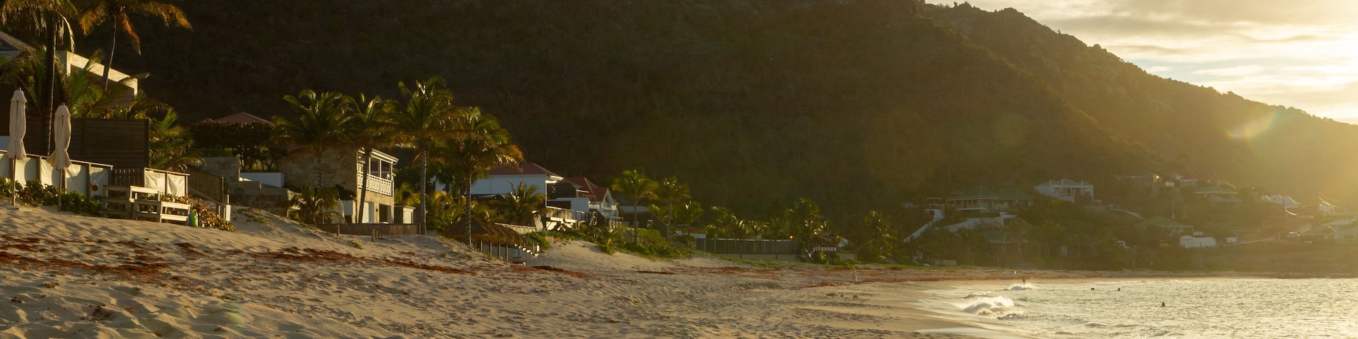 Flamands Beach which includes a sunset, a beach and a coastal town