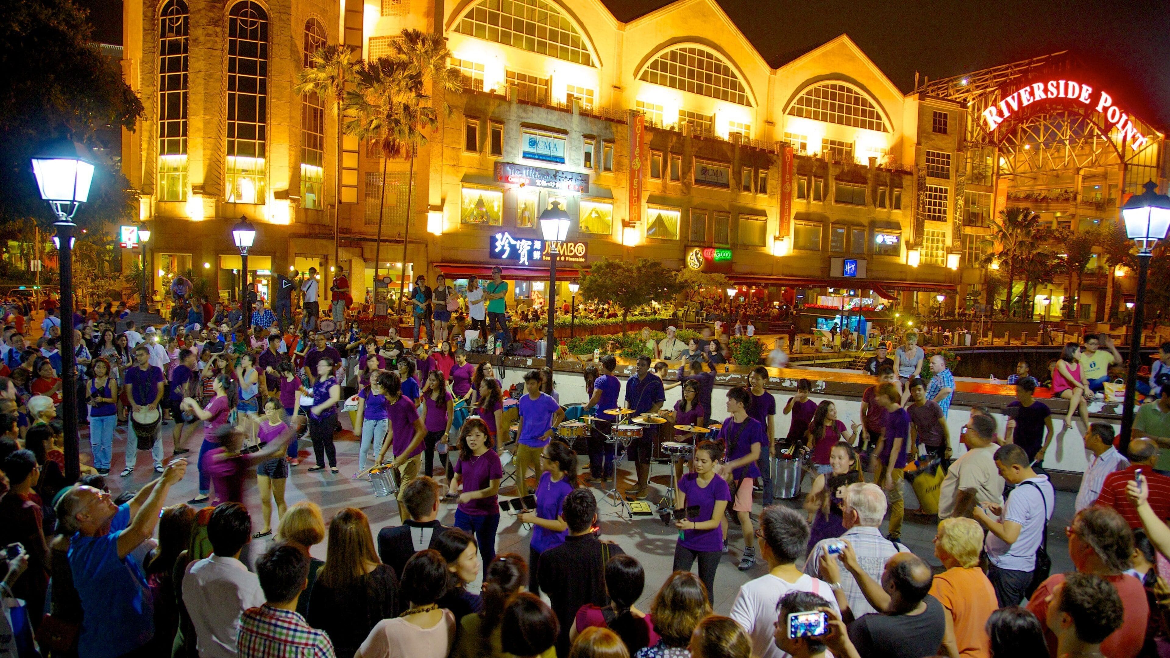 Clarke Quay which includes a city, performance art and modern architecture