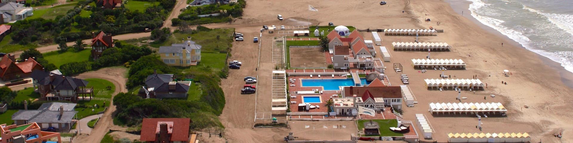 Pinamar showing a sandy beach and a coastal town