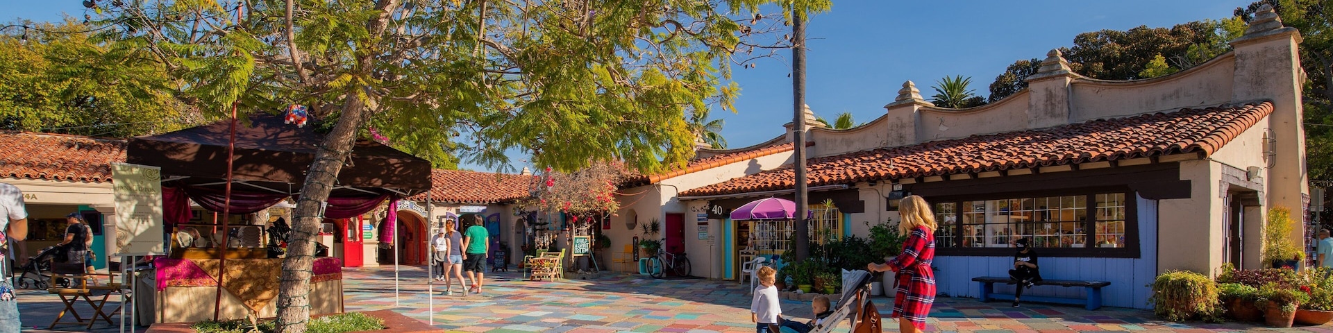 Spanish Village Art Center featuring street scenes as well as a family