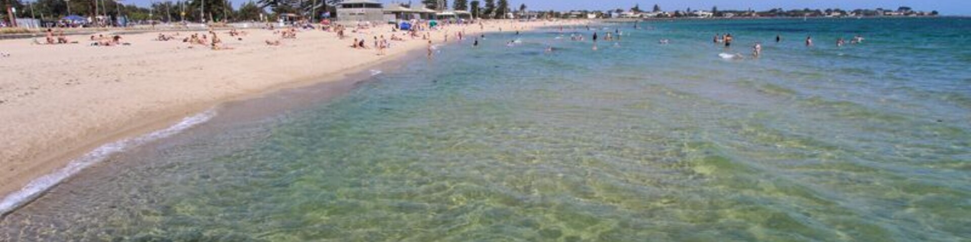 Elwood Beach in Melbourne is a popular bayside beach during sunny days and a great family beach. It’s not as accessible from the city as St Kilda as it’s not exactly on the tram or train line, but still only 8km’s away if you have a car, or jump in a cab.
The water was clean and calm for swimming and our kids had a great time playing on the sand and the rocks. It’s another fairly active beach and you’ll see people windsurfing, cycling, playing cricket and walking.