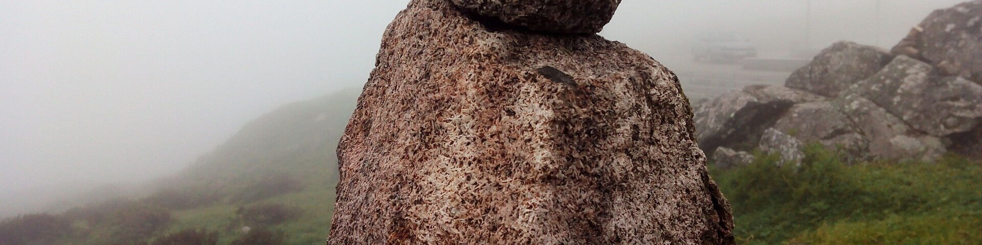 Rocks & sightseeing at the top of a mountain in a foggy day