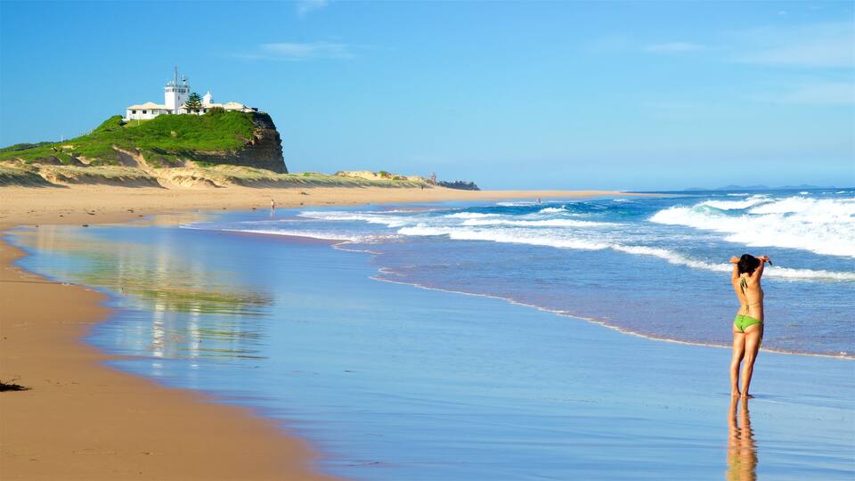 Newcastle East featuring a sandy beach and general coastal views as well as an individual femail