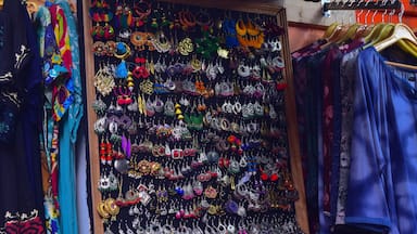 Exposição de joias e roupas coloridas numa loja.