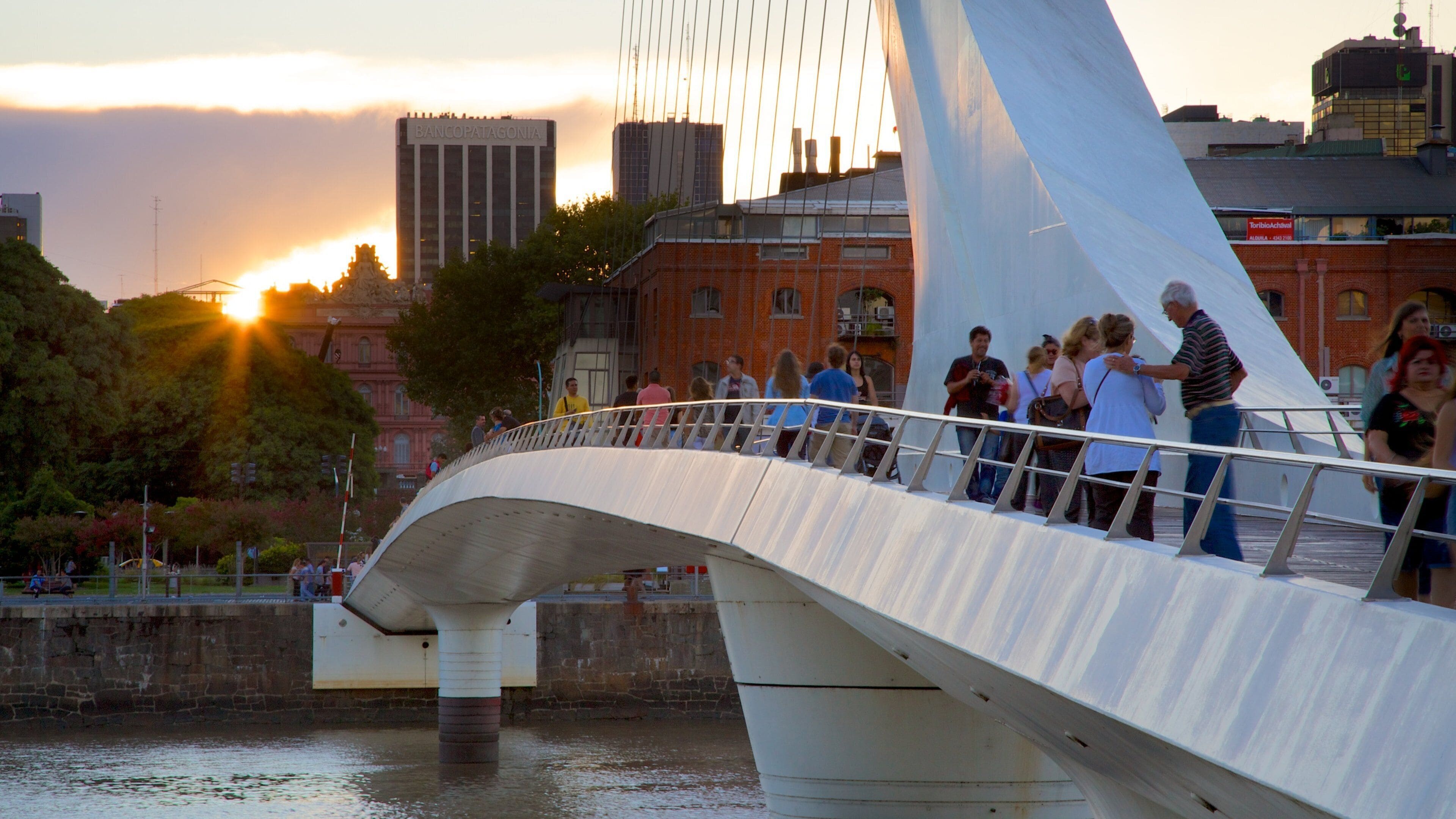 Puerto Madero which includes a sunset, a bridge and modern architecture