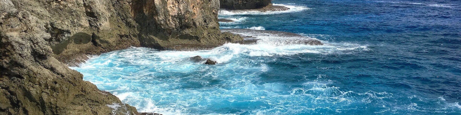 There is a short hike through dense jungle to get to the cave and the look out. The cave is a short ways before and after a short swim and squeeze through a small opening you see a pretty large room, completely dark (bring some sort of light source). You can cliff jump from the lookout or just see a beautiful shoreline. #guam