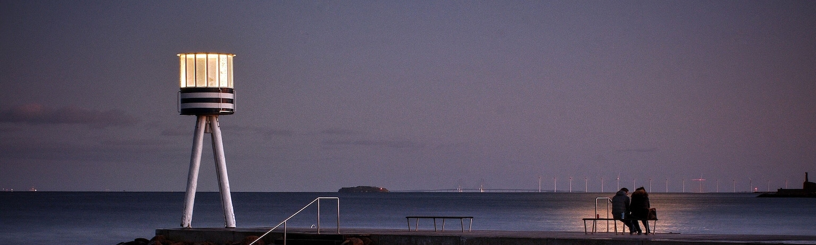 This nice beach is fantastic even in the moonlight. The old lifeguard tower, designed by the famous danish architect Arne Jacobsen, now shines beautiful almost like a lighthouse. Notice the lovers on the bench in the moonlight, sharing a perfect evening by the sea.
#culture #moonlight #beach #coastline