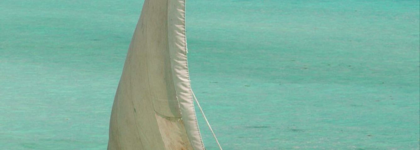 After weeks travelling across souther Africa a few days rest in Zanzibar, sandy beach cool drink and watching tge local fishermen