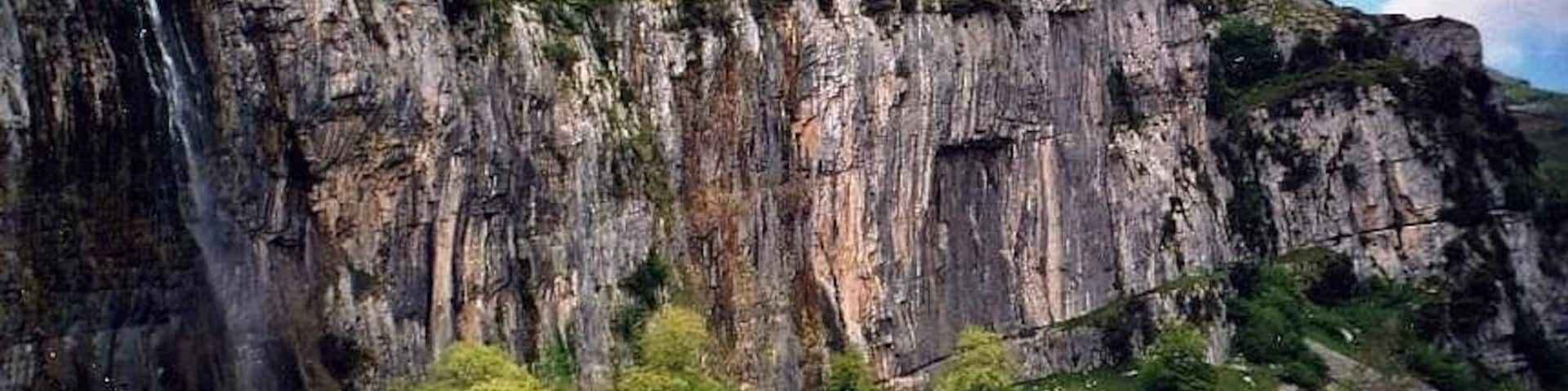 Source of the river Ason in the Natural Park Hillocks of the Ason (Cantabria, Spain). Resurgent stream in a karst region. The water falls by a cascade of more than 50 meters of height.