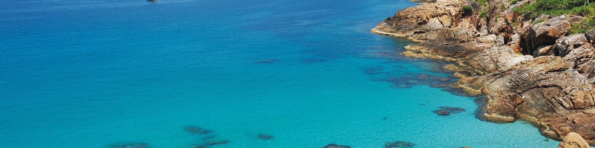 Pulau Perhentian Besar which includes general coastal views, rugged coastline and jet skiing