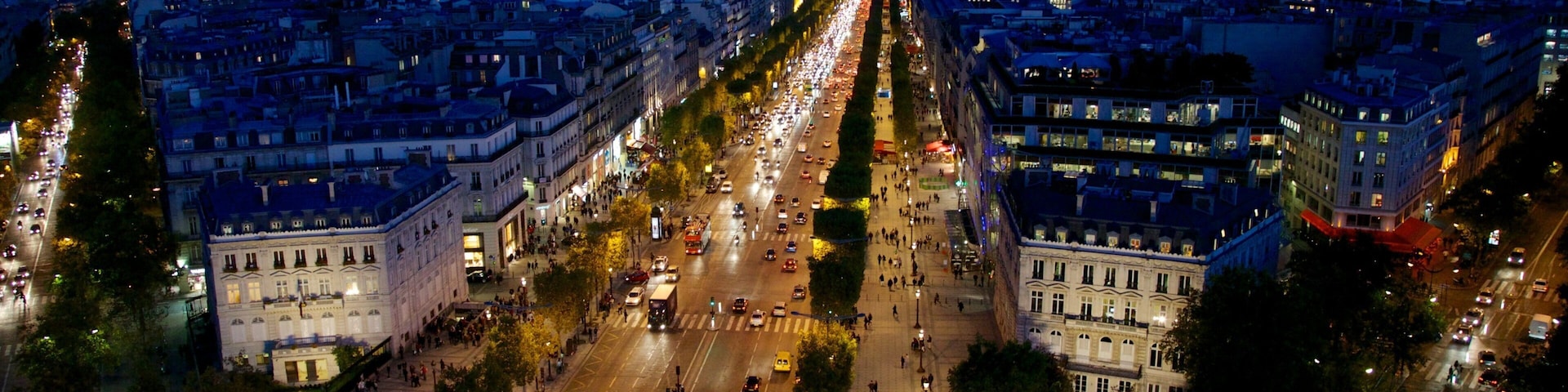 Vibrant evening view of Champs-Elysees illuminated with streetlights in Paris, Île-de-France