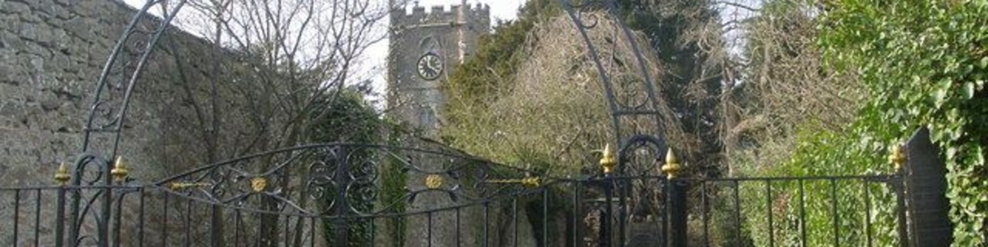 St Nicholas church, Brockley The wrought iron gates open to the footpath to the churchyard proper. The church is now redundant.