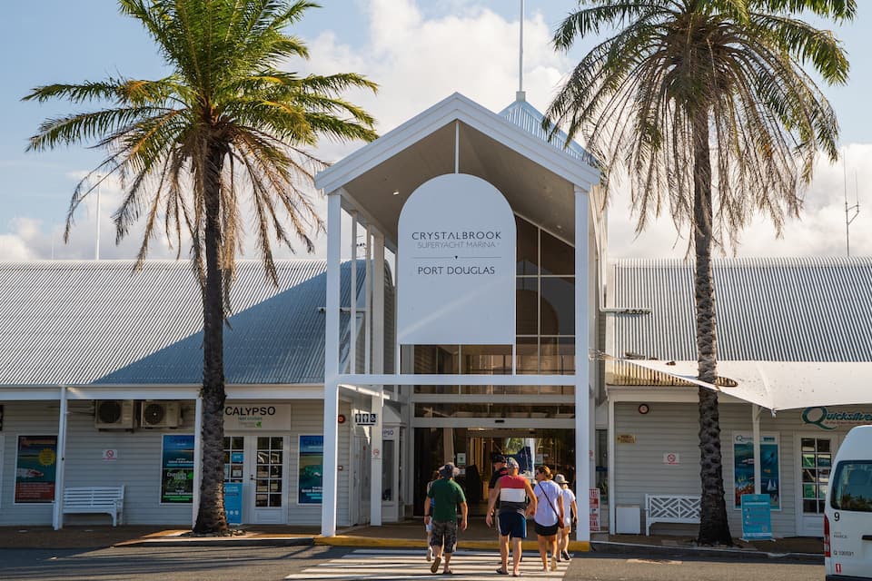 Um edifício de marina com uma placa que diz "Crystalbrook Superyacht Marina Port Douglas".