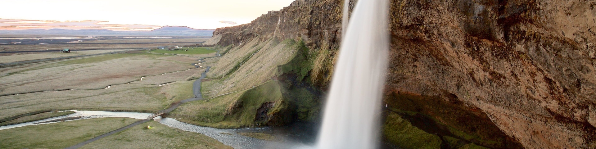 South Iceland which includes landscape views, a sunset and a waterfall