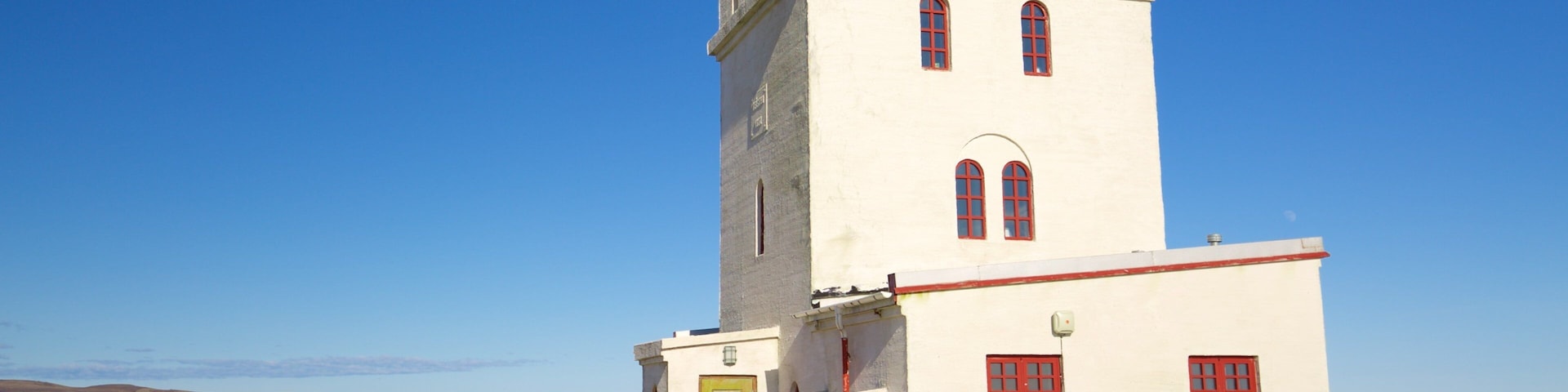 Dyrholaey featuring a lighthouse and general coastal views
