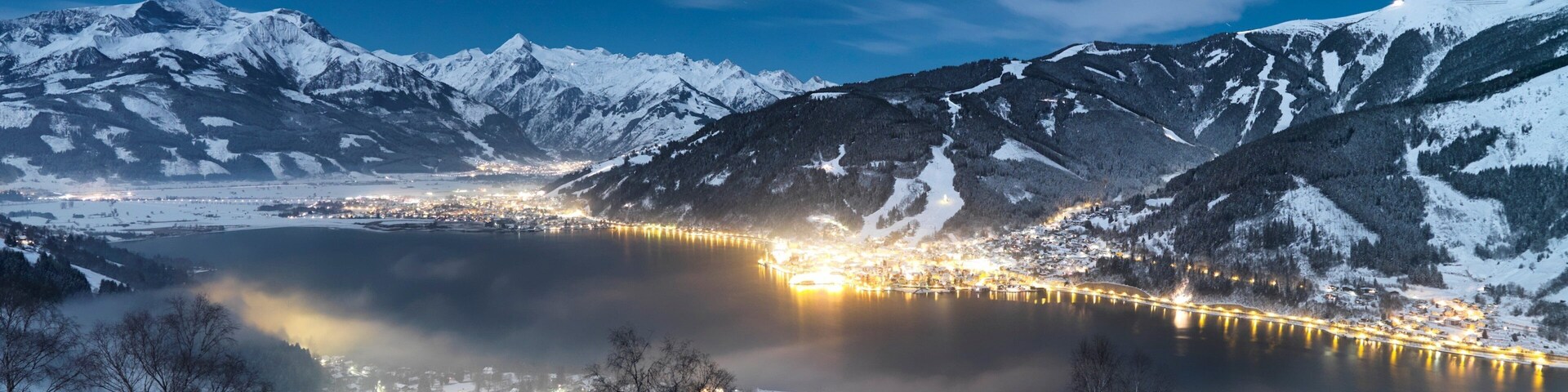Zell am See-Kaprun featuring a lake or waterhole, night scenes and snow
