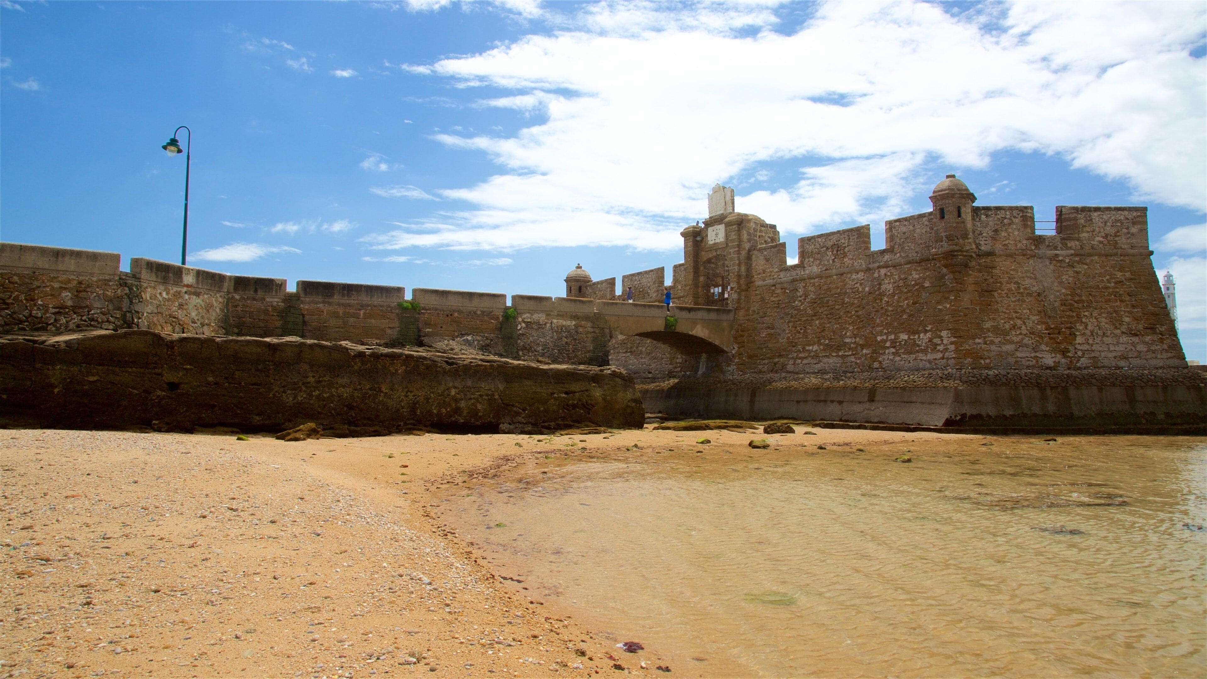 Fortress of San Sebastian featuring a sandy beach and heritage elements