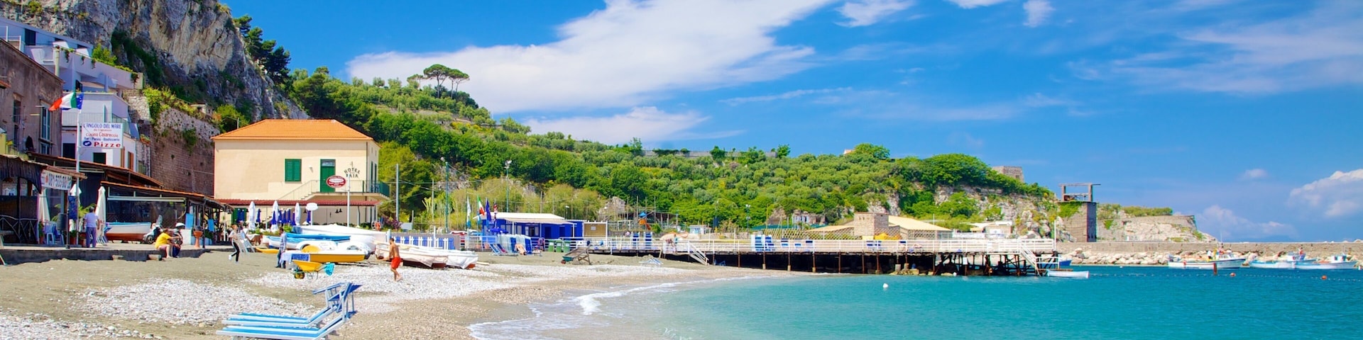 Marina di Puolo featuring a bay or harbor, a pebble beach and a coastal town