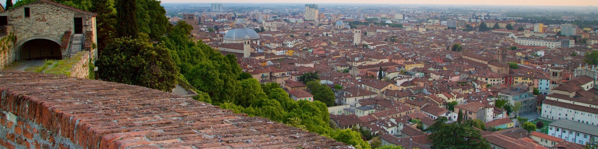 Brescia Castle which includes a sunset, landscape views and a city