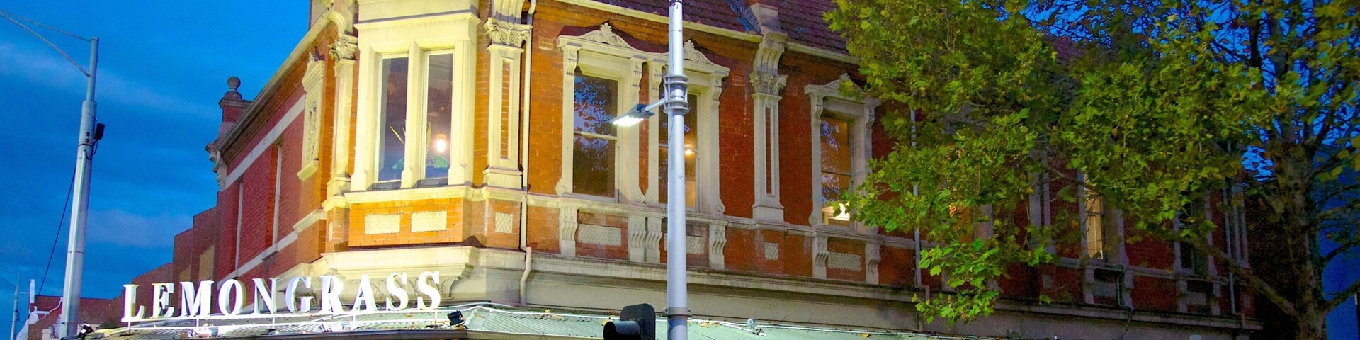 Lygon Street which includes signage, heritage architecture and a city