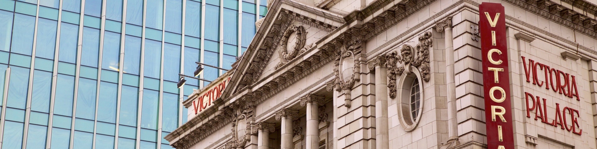 Victoria Palace Theatre featuring heritage architecture, signage and theater scenes