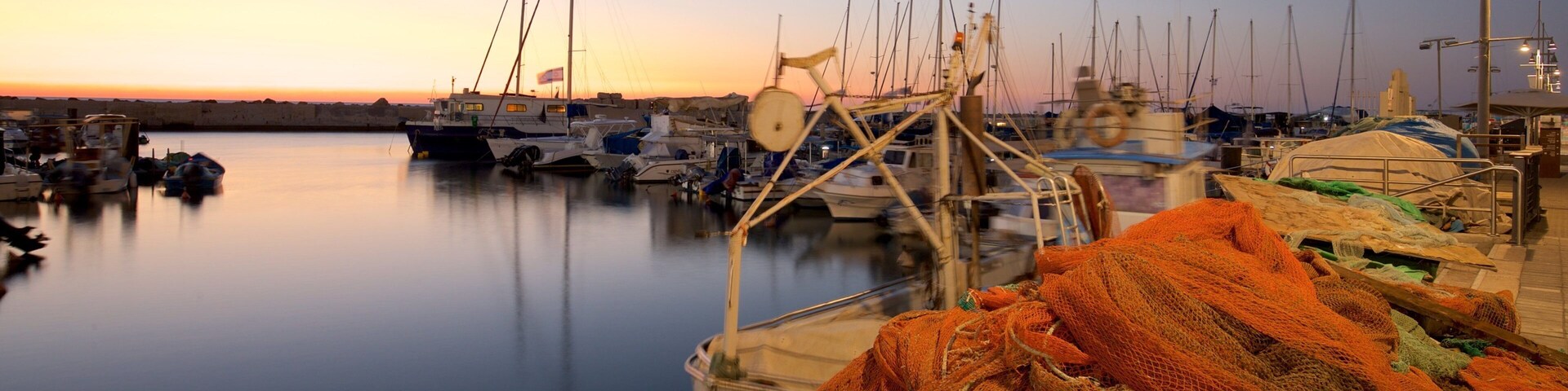 Jaffa Port featuring a bay or harbor and a sunset