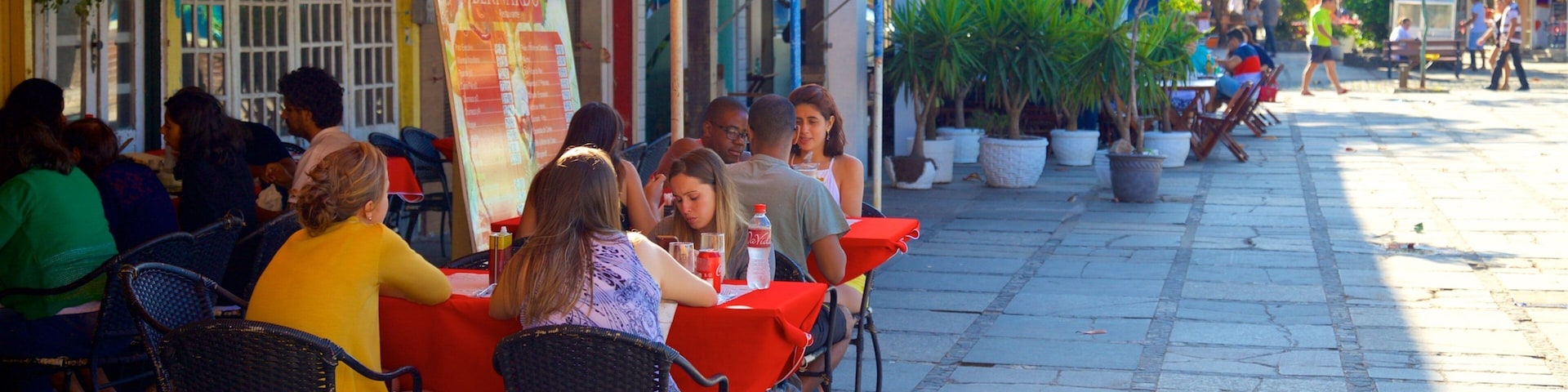 Santos Dumont Square which includes outdoor eating as well as a small group of people