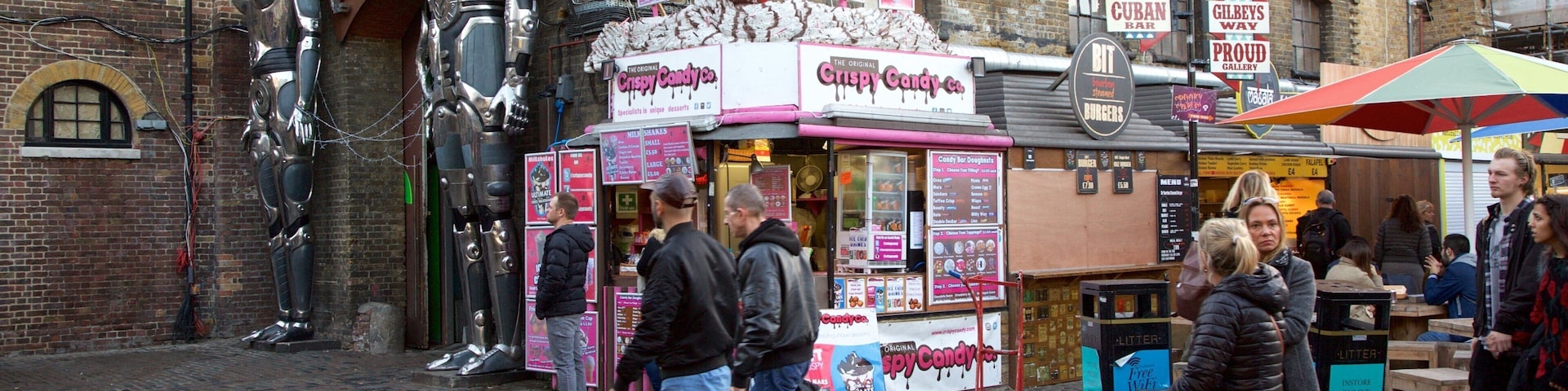 Camden Markets showing signage, markets and a statue or sculpture