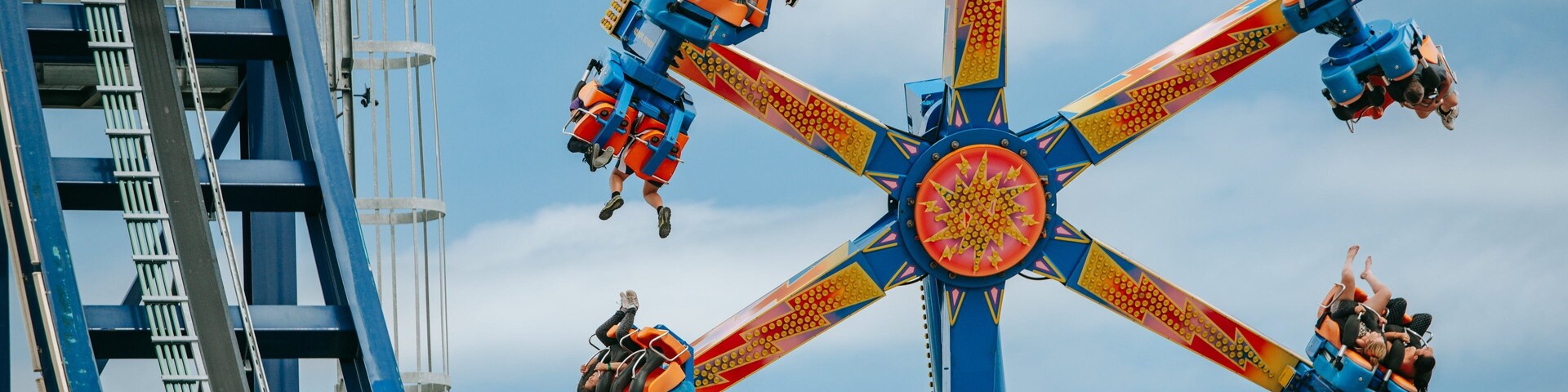 Rainbow\'s End featuring rides as well as a small group of people