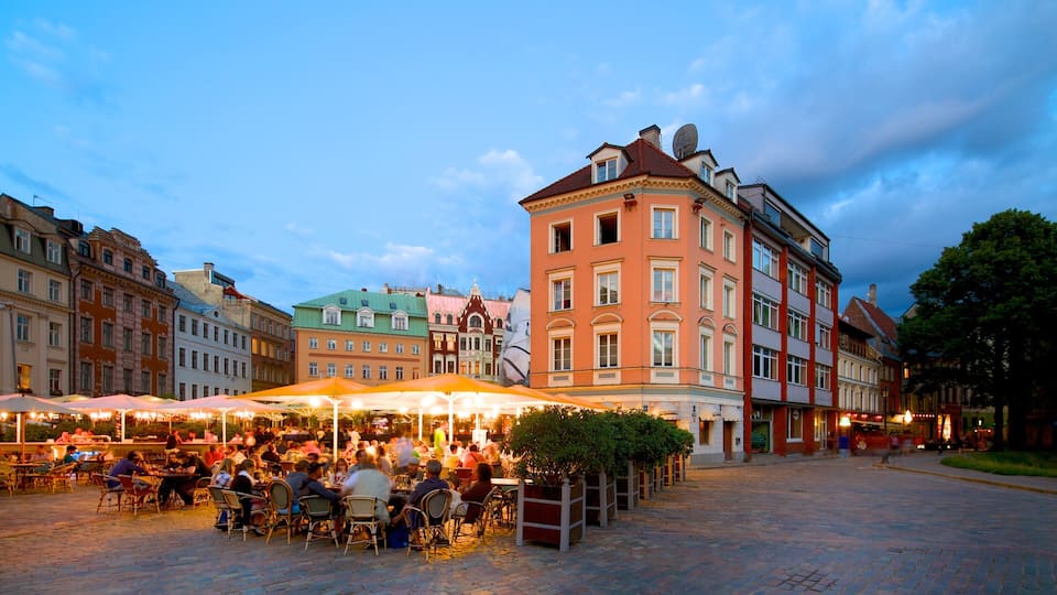 Uma praça de paralelepípedos com cafés ao ar livre e edifícios históricos.