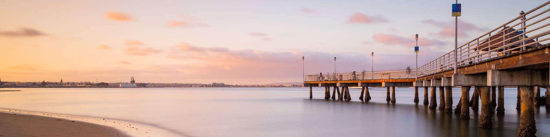 Coronado Ferry Landing featuring general coastal views, a sandy beach and a sunset