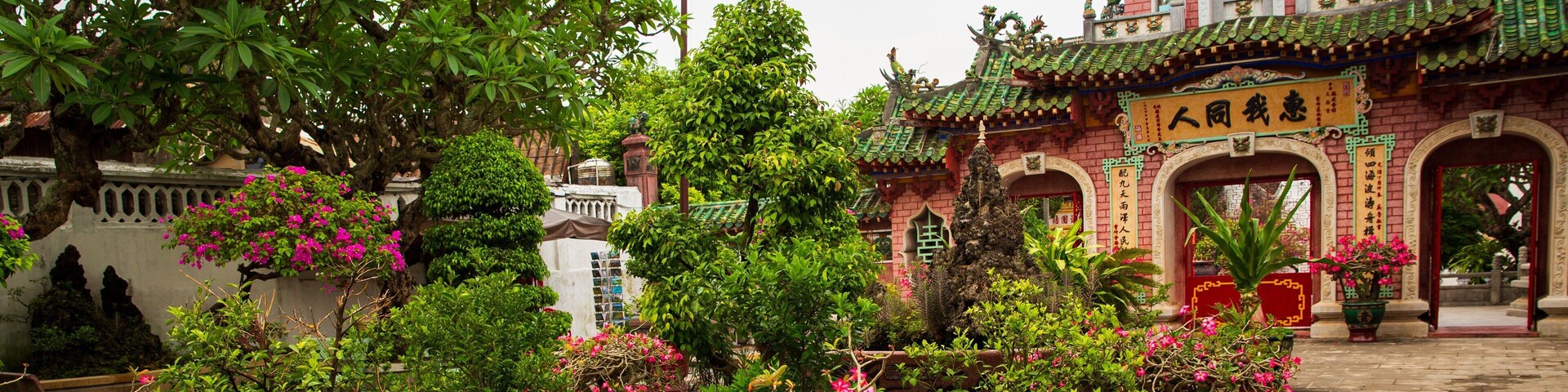 Assembly Hall of the Fujian Chinese Congregation showing a park, heritage architecture and wildflowers