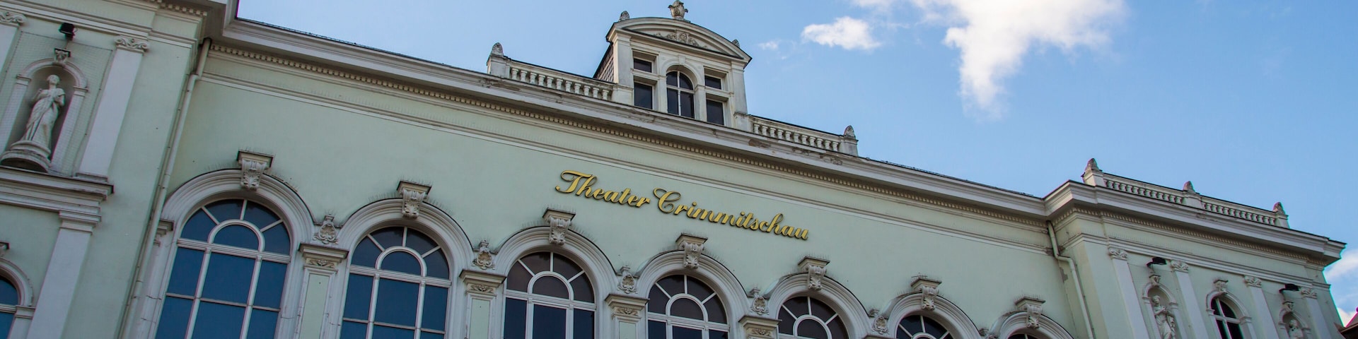 Um edifício histórico com janelas em arco e uma cúpula.