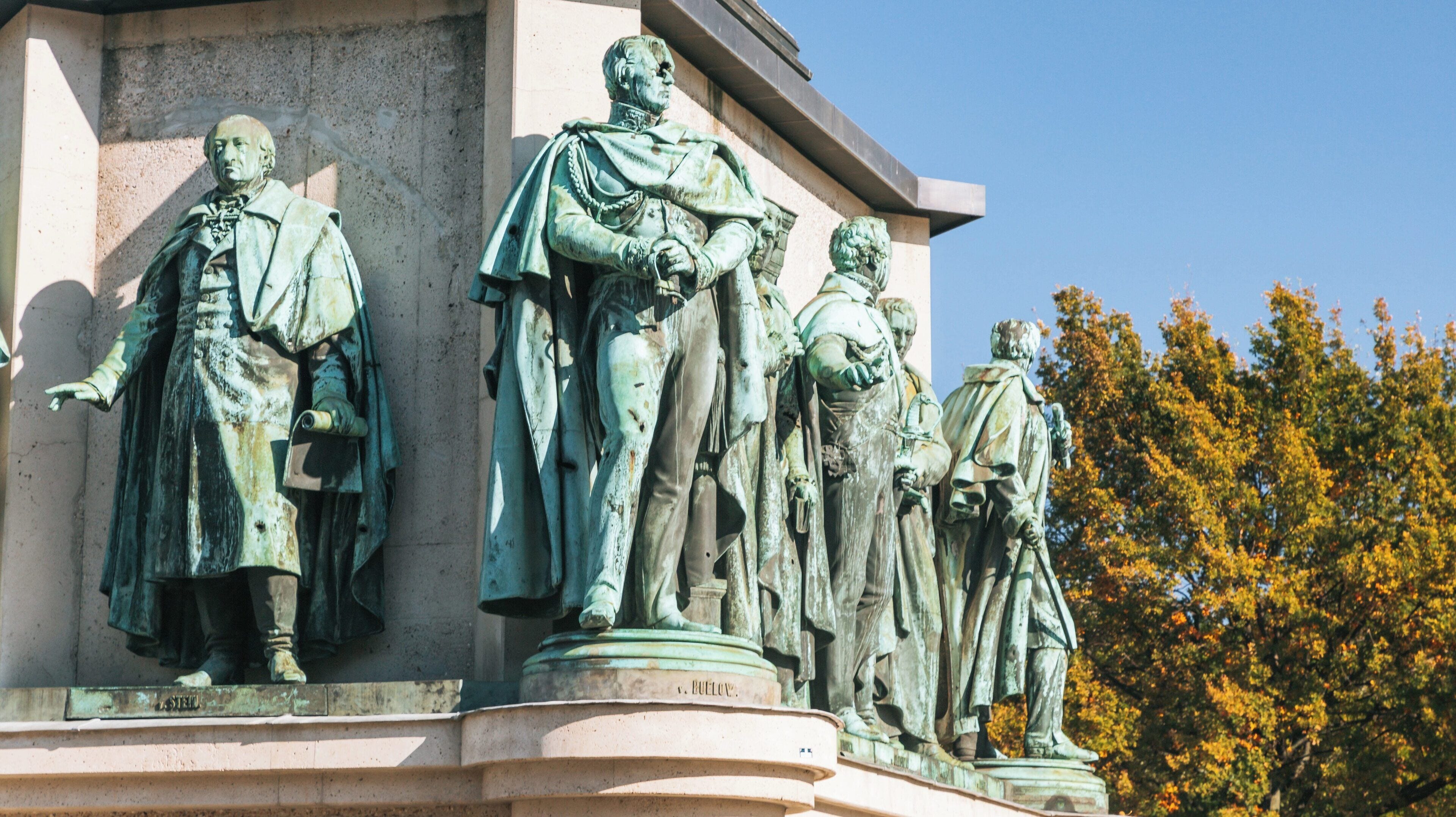 Exploring Hay Market in Altstadt-Nord, Cologne with Historical Statues and Vibrant Autumn Foliage