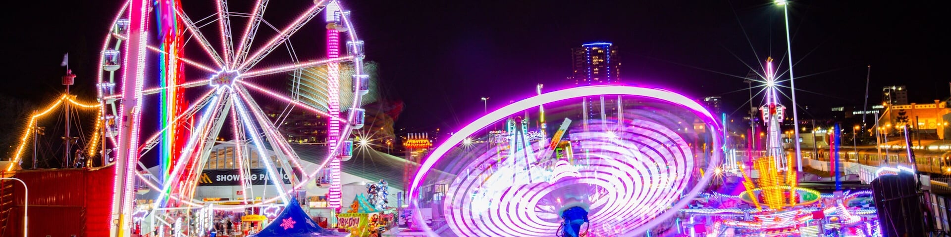 RNA Showgrounds featuring rides and night scenes