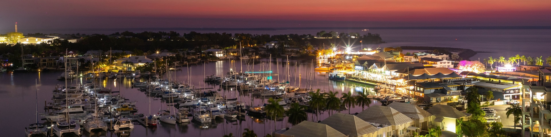 Cullen Bay Marina which includes a coastal town, a bay or harbor and night scenes