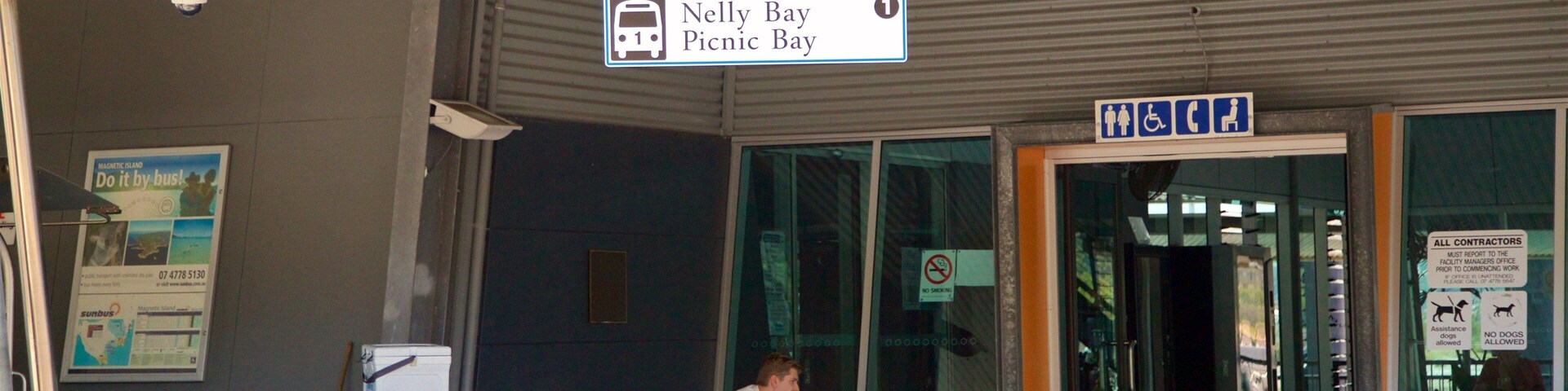 Magnetic Island Ferry Terminal featuring signage as well as an individual male