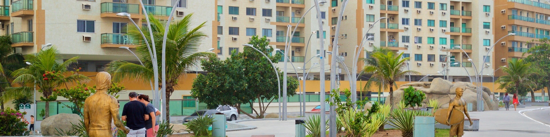 Aguas Square featuring a statue or sculpture and a park as well as a couple