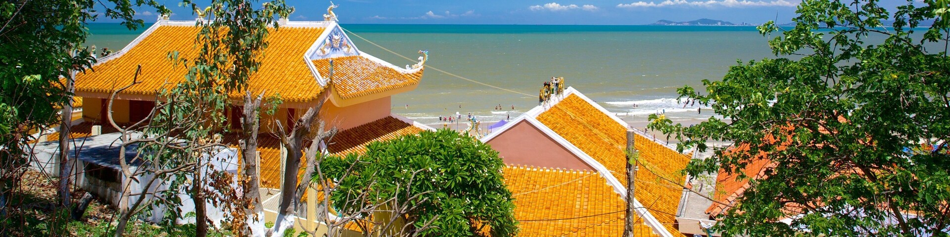 Dinh Co Temple which includes a coastal town, a temple or place of worship and general coastal views