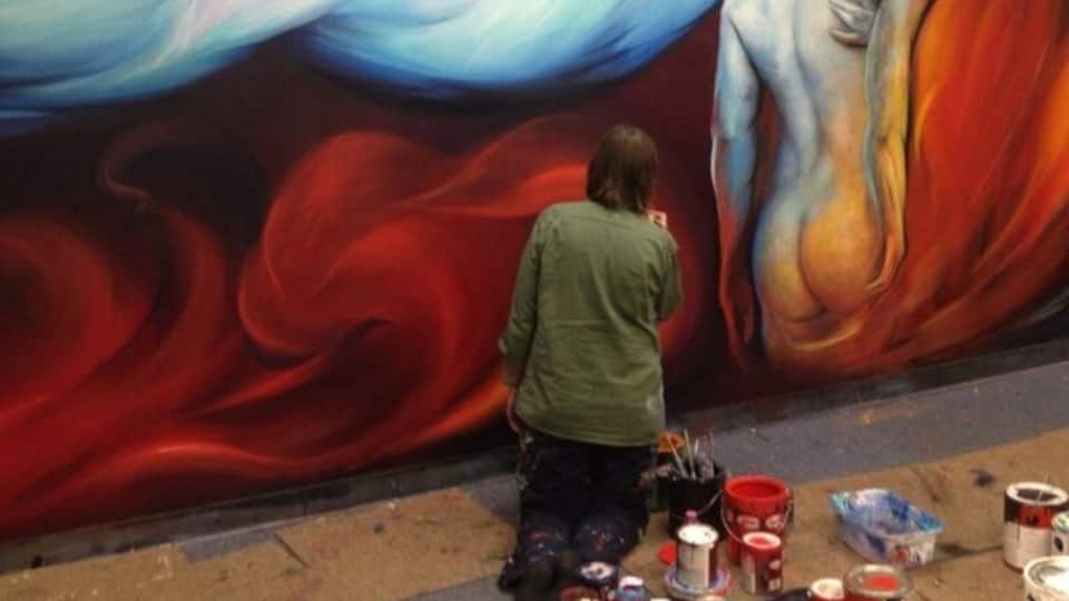 Muralist at work at Artomatic 2012.