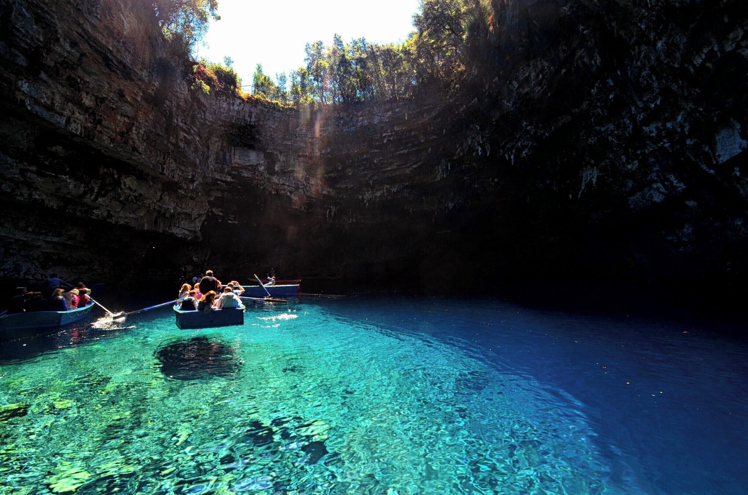 #Melissani Cave also known as Cave of the Nymphs in #Kefalonia, Greece is one of the hidden travel treasures that is a must visit for any avid traveller. Feel mesmerized by the deep #blue water, which turns crystal clear once the sun rays shine upon the lake from atop.