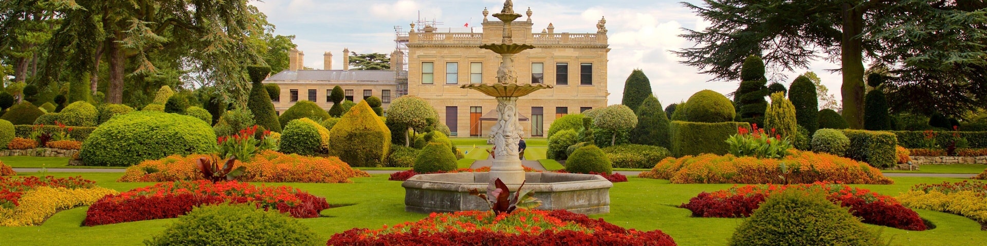 Brodsworth Hall featuring a garden, a fountain and flowers