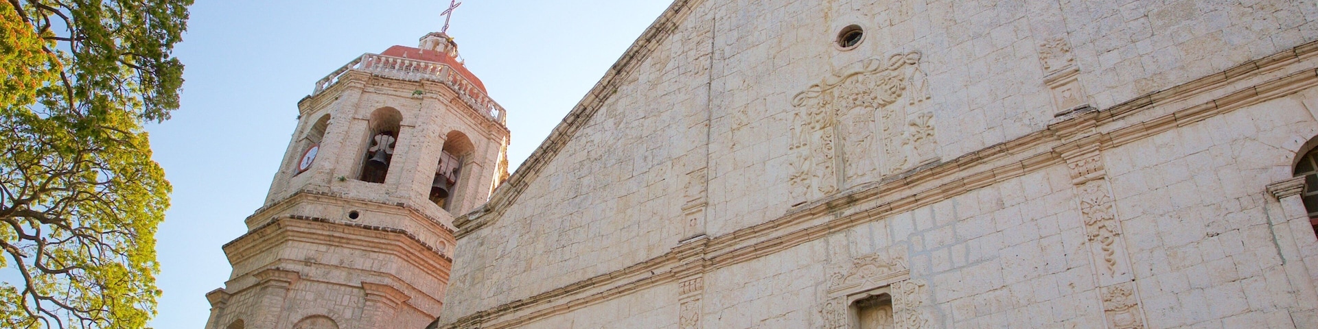 Dalaguete Church which includes a sunset, religious aspects and a church or cathedral