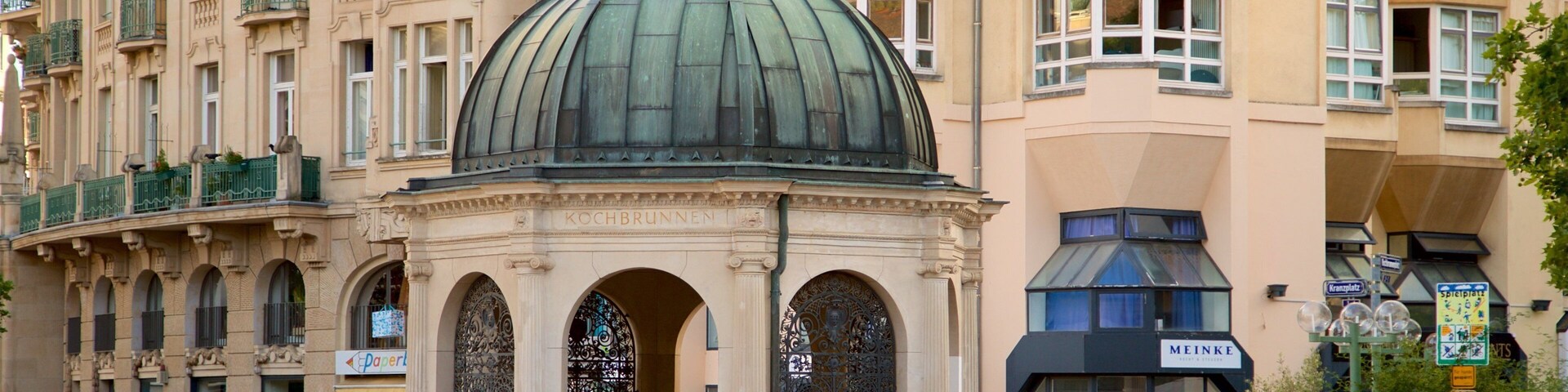 Um edifício histórico com uma cúpula imponente e portões de ferro elaborados.