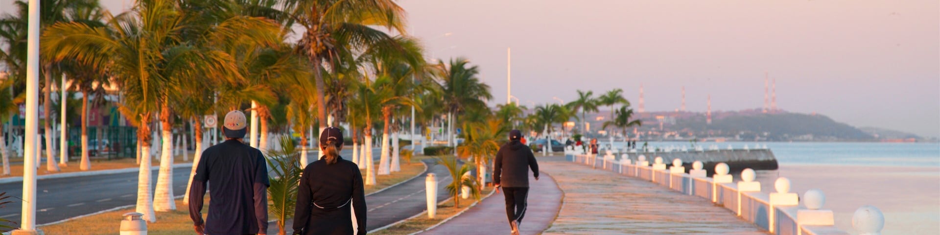 Campeche Waterfront Promenade showing hiking or walking and a sunset as well as a couple