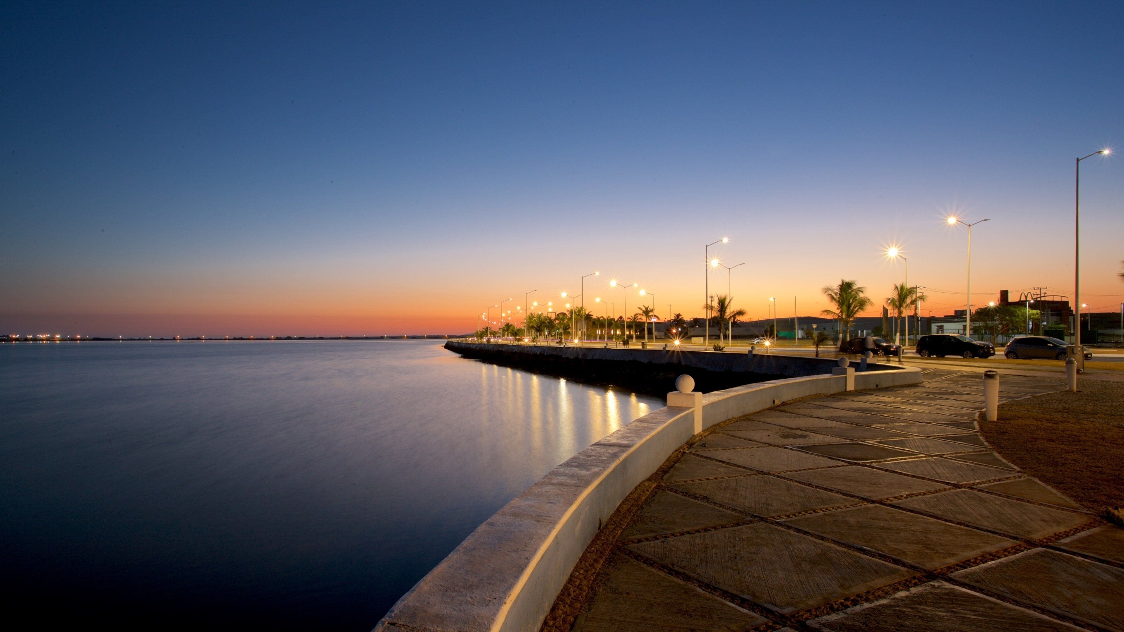 Campeche Waterfront Promenade featuring a bay or harbor and a sunset
