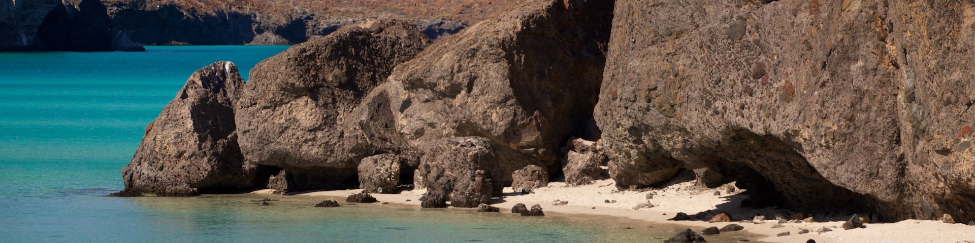 Balandra Beach featuring rugged coastline, a beach and general coastal views