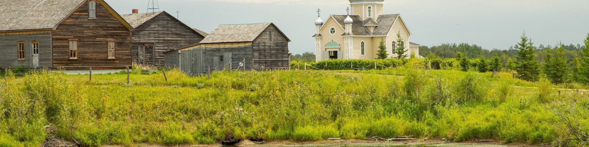 Ukrainian Cultural Heritage Village featuring a pond, a small town or village and a mosque