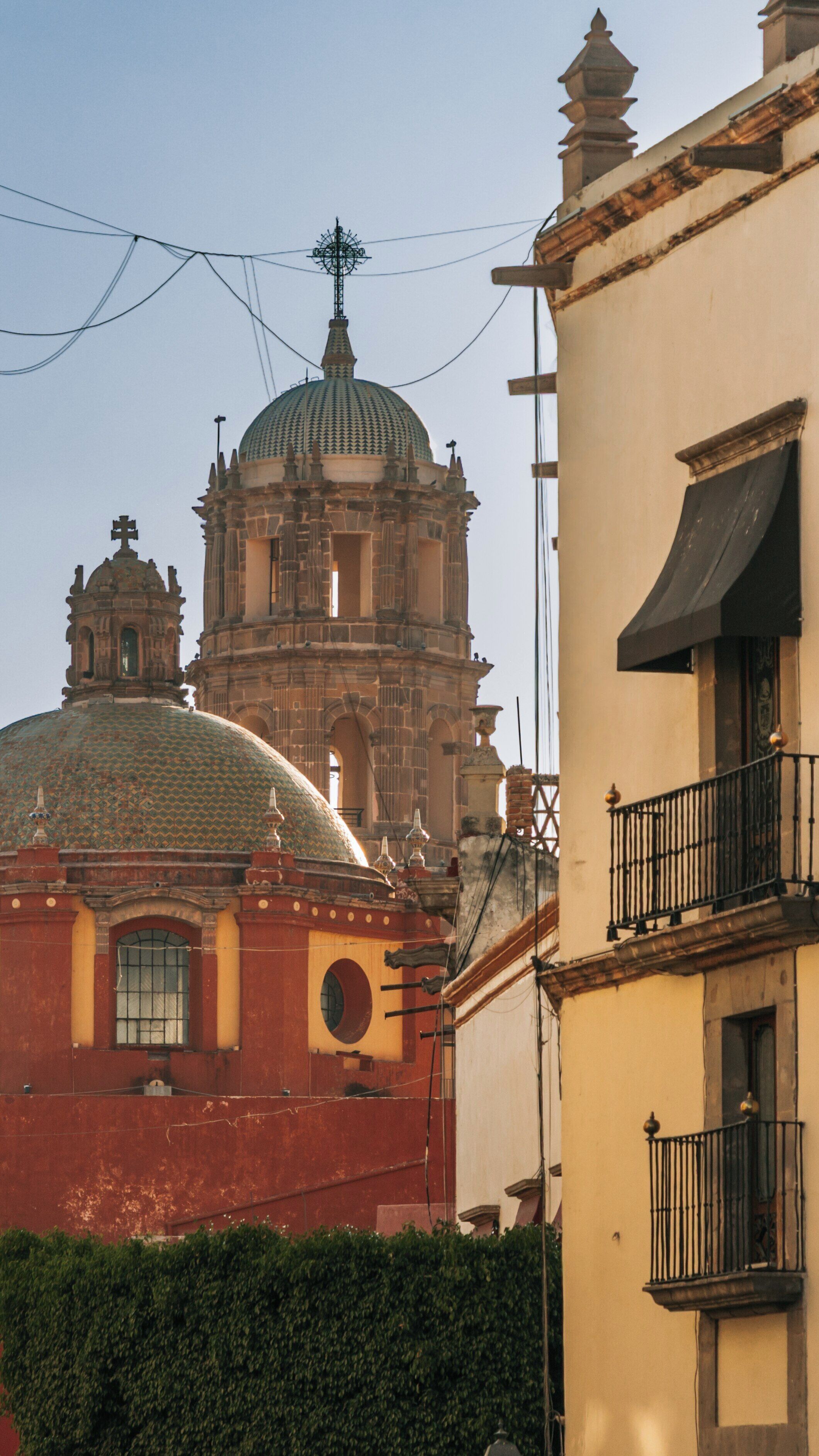 Beautiful architecture in Plaza de Armas, Downtown Queretaro features stunning domes and intricate designs from a warm afternoon perspective
