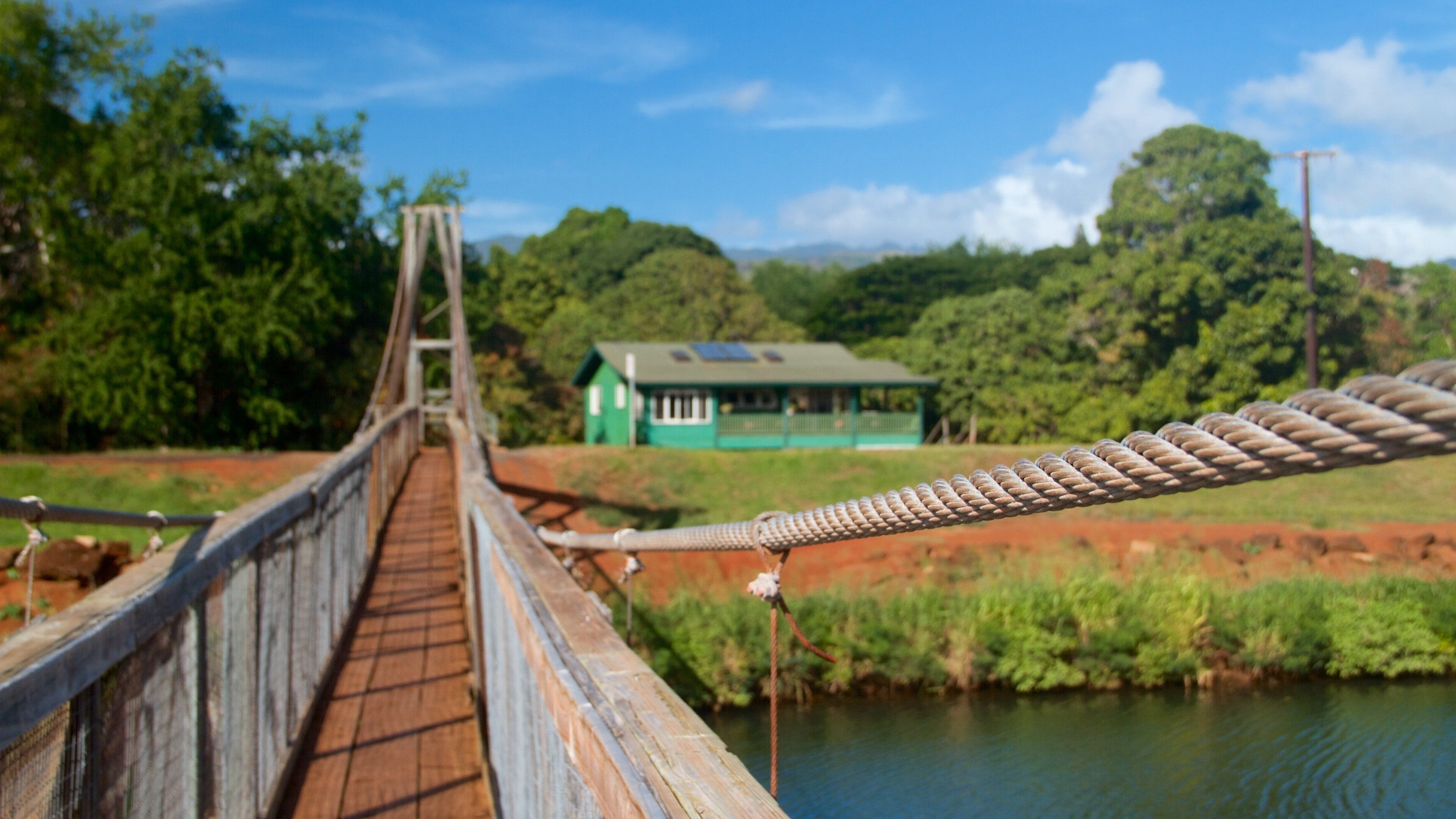 Swinging Bridge which includes a house, a bridge and a river or creek